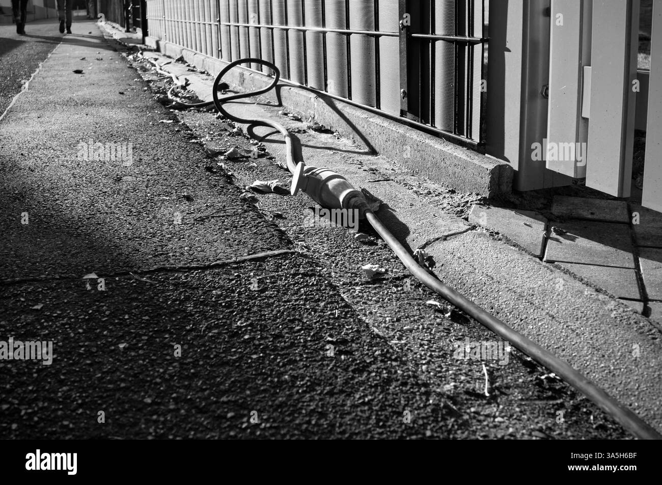 Perspective view at an electical cable with extension cord lying on the ...