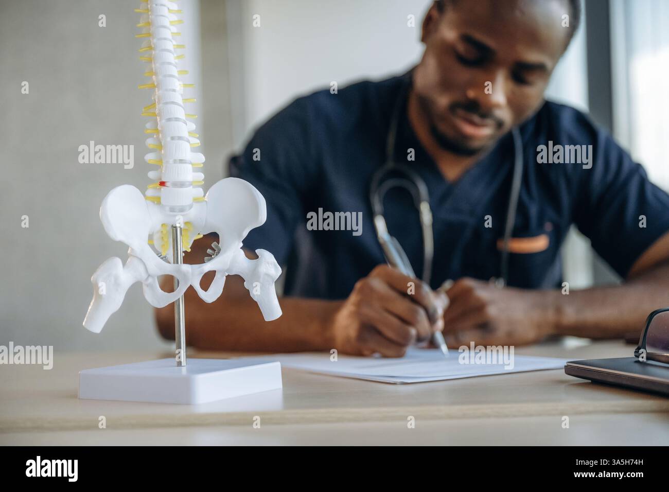 Writing info into the document. Professional doctor is in his office ...