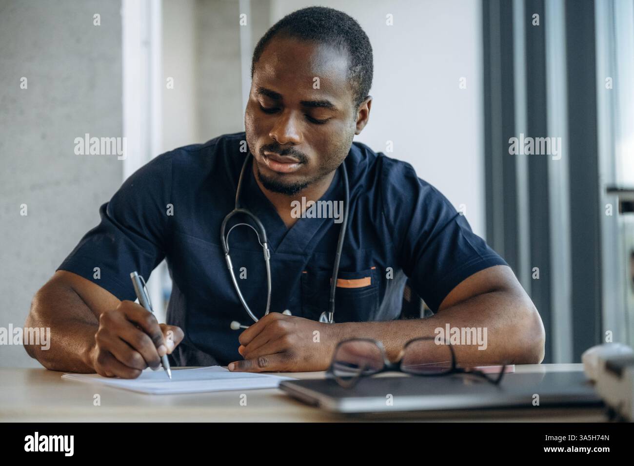 Writing info into the document. Professional doctor is in his office ...