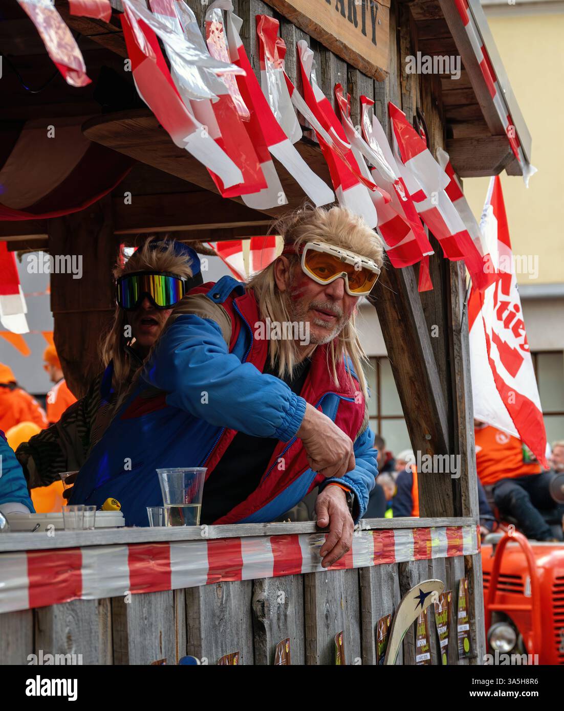 member of the group "Apres ski WM party" throwing sweets at the ...