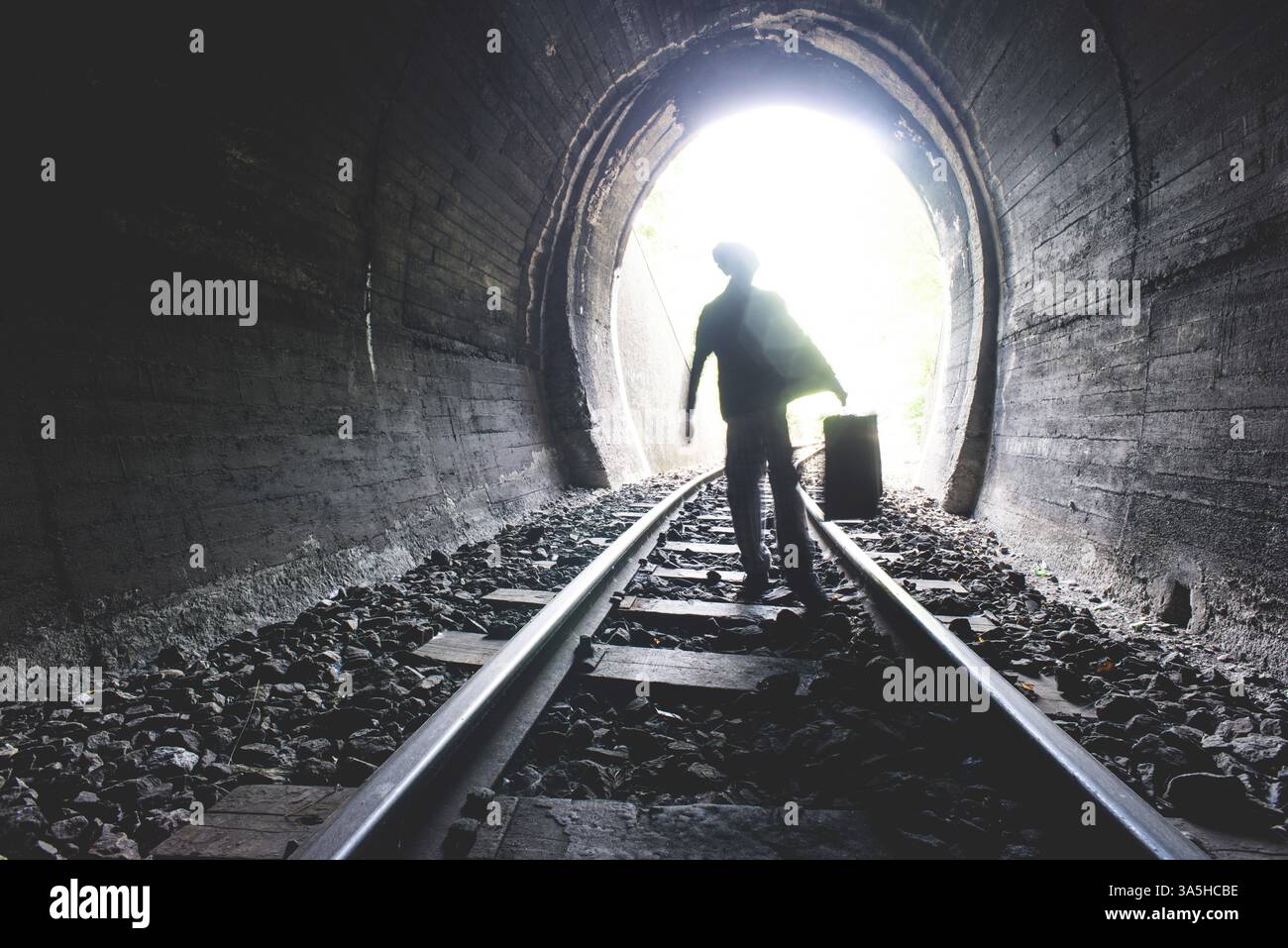 Child walking in railway tunnel. Vintage clothes Stock Photo - Alamy