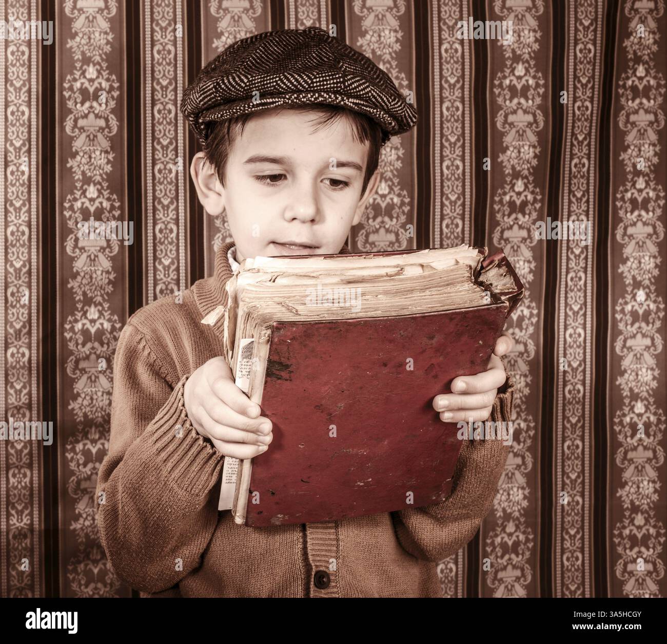 Child with red vintage book. Vintage clothes and hat Stock Photo - Alamy