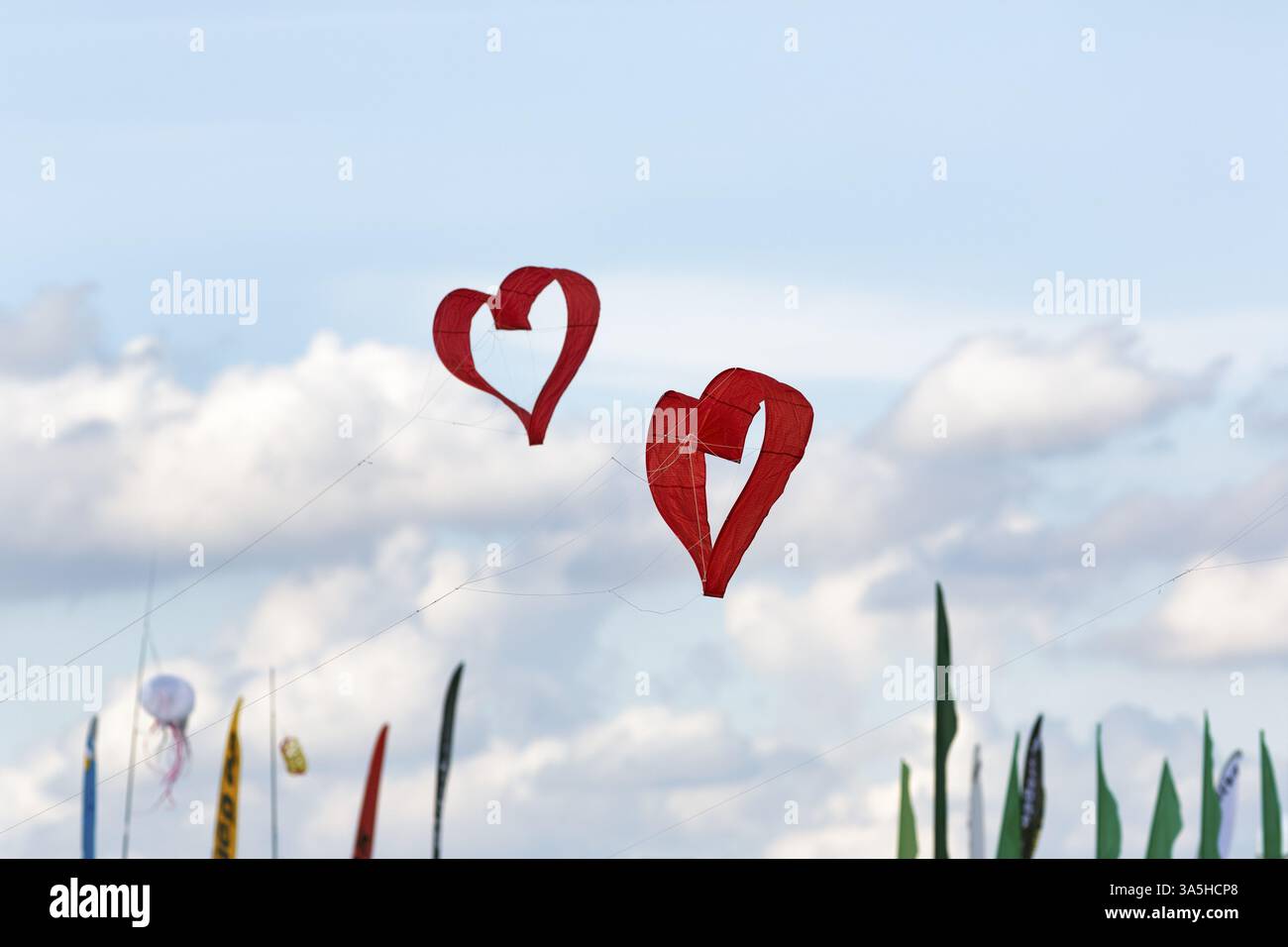 Two red heart-shaped kites flying in the sky, text free space, kite ...