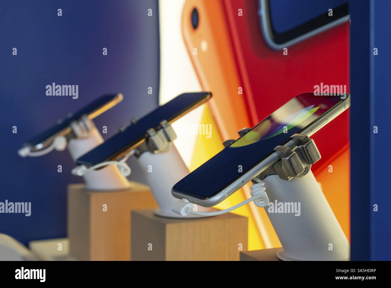 Cell Phones on shelf in telecommunication shop. Lights over GSM phones ...