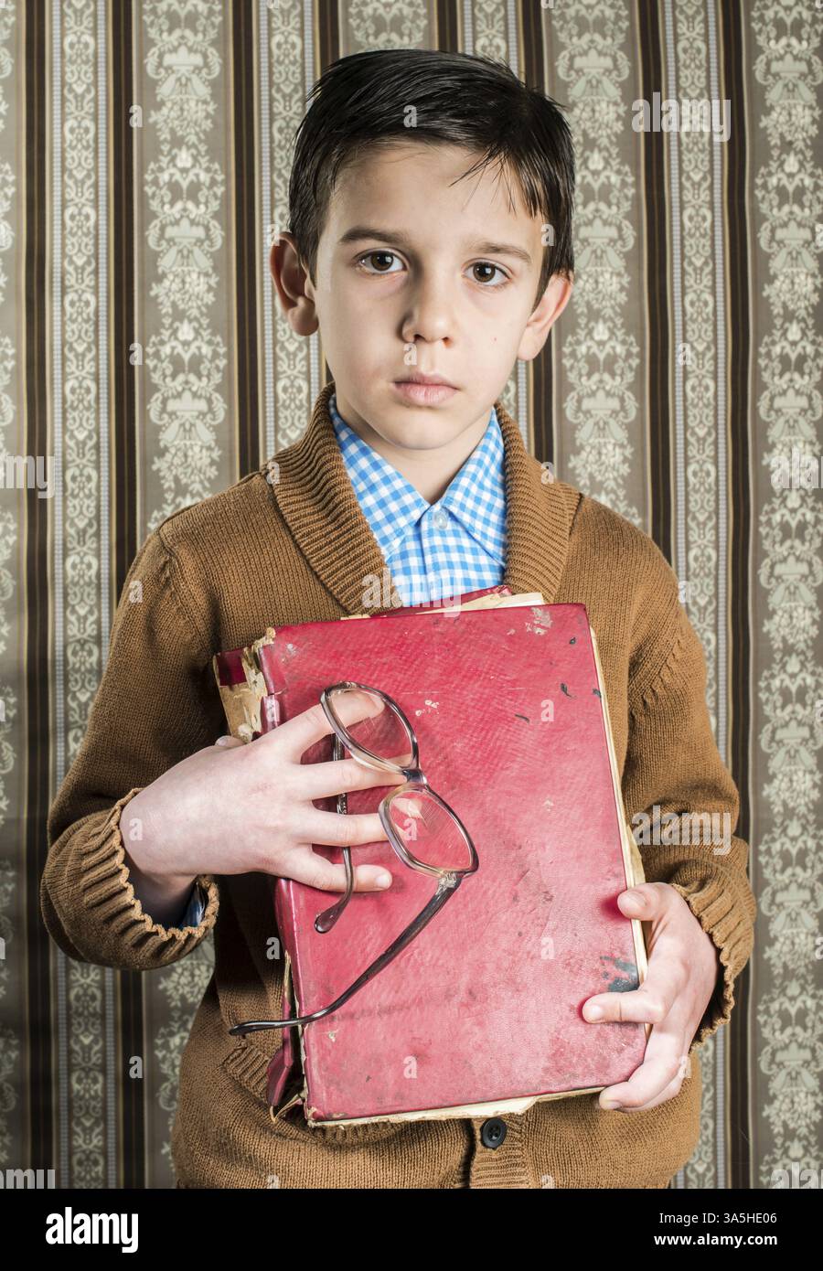 Child with red vintage book. Vintage clothes Stock Photo - Alamy