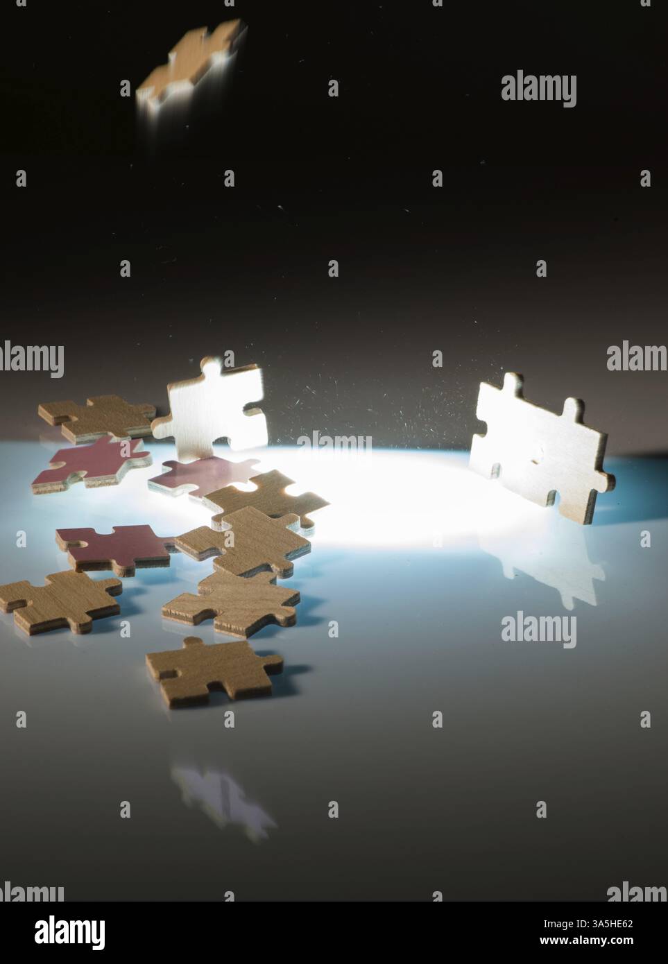 Falling puzzle pieces.Backlight background Stock Photo - Alamy