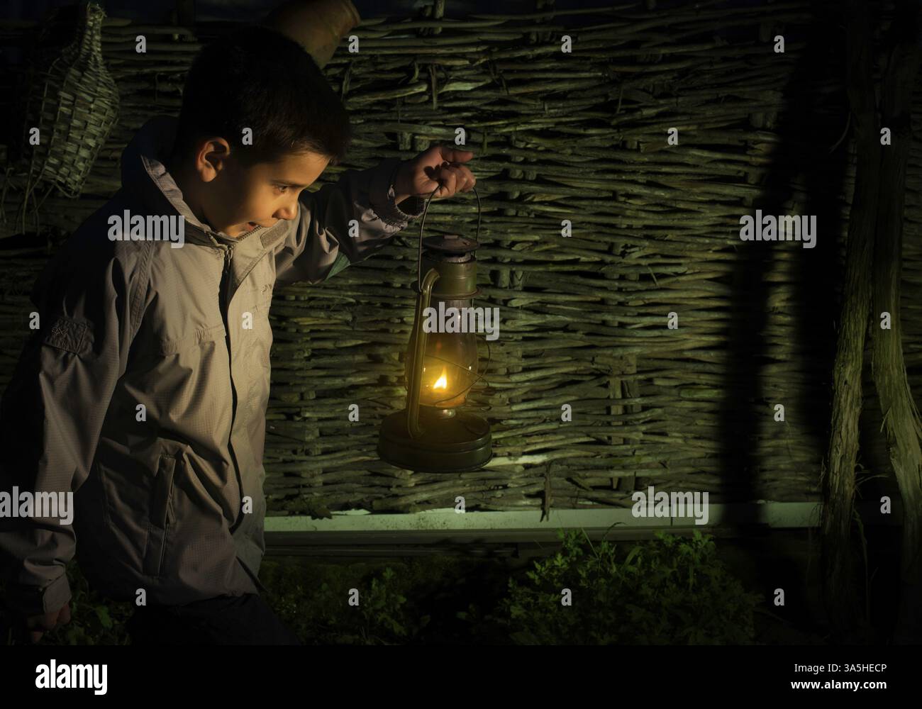 Child walk in the darkness with gas lantern Stock Photo - Alamy