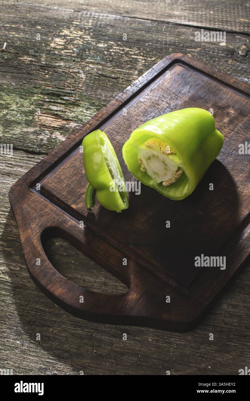 Cut green pepper on wood. Backlight Stock Photo - Alamy