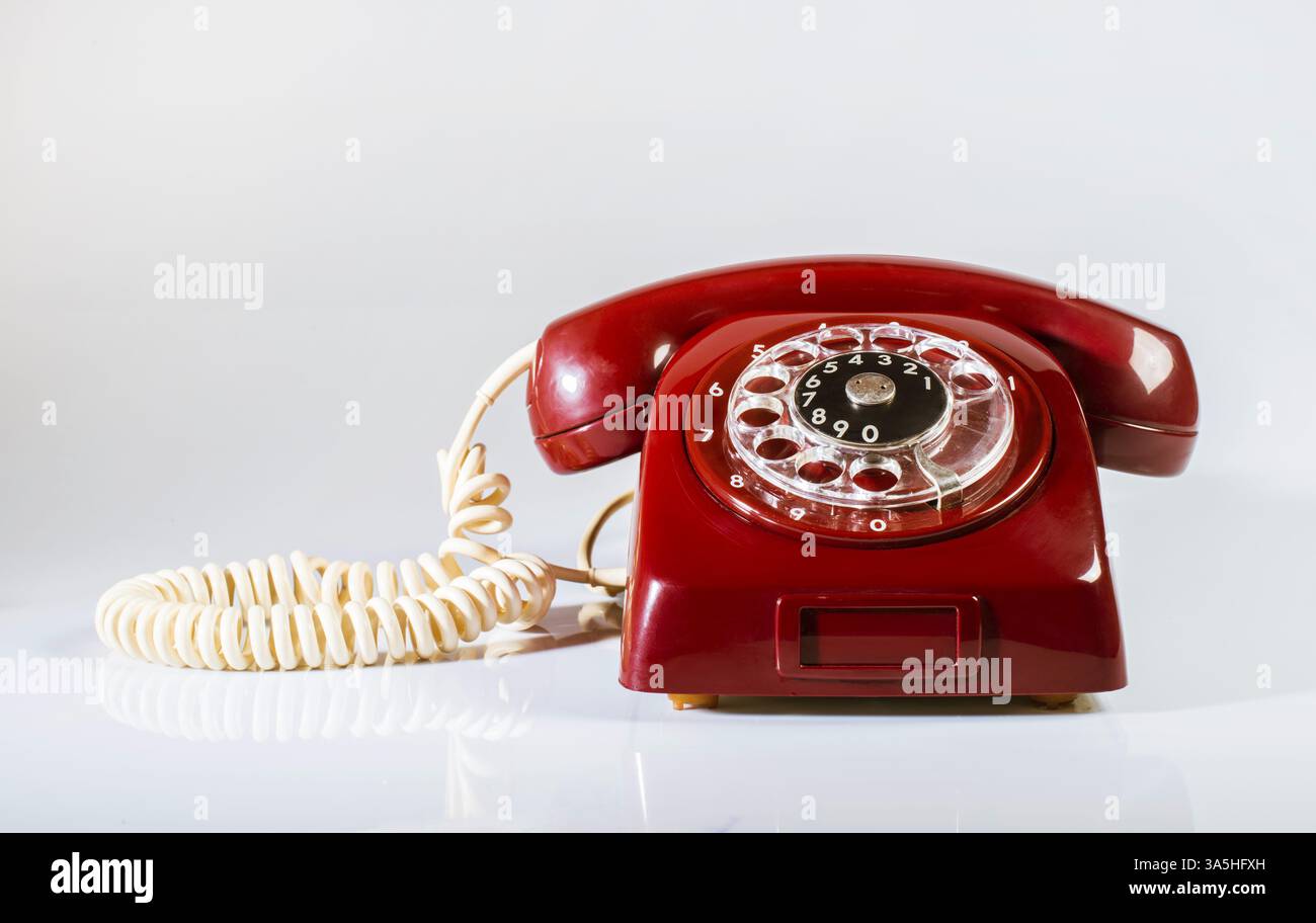 Vintage red phone on white background. White cable Stock Photo - Alamy