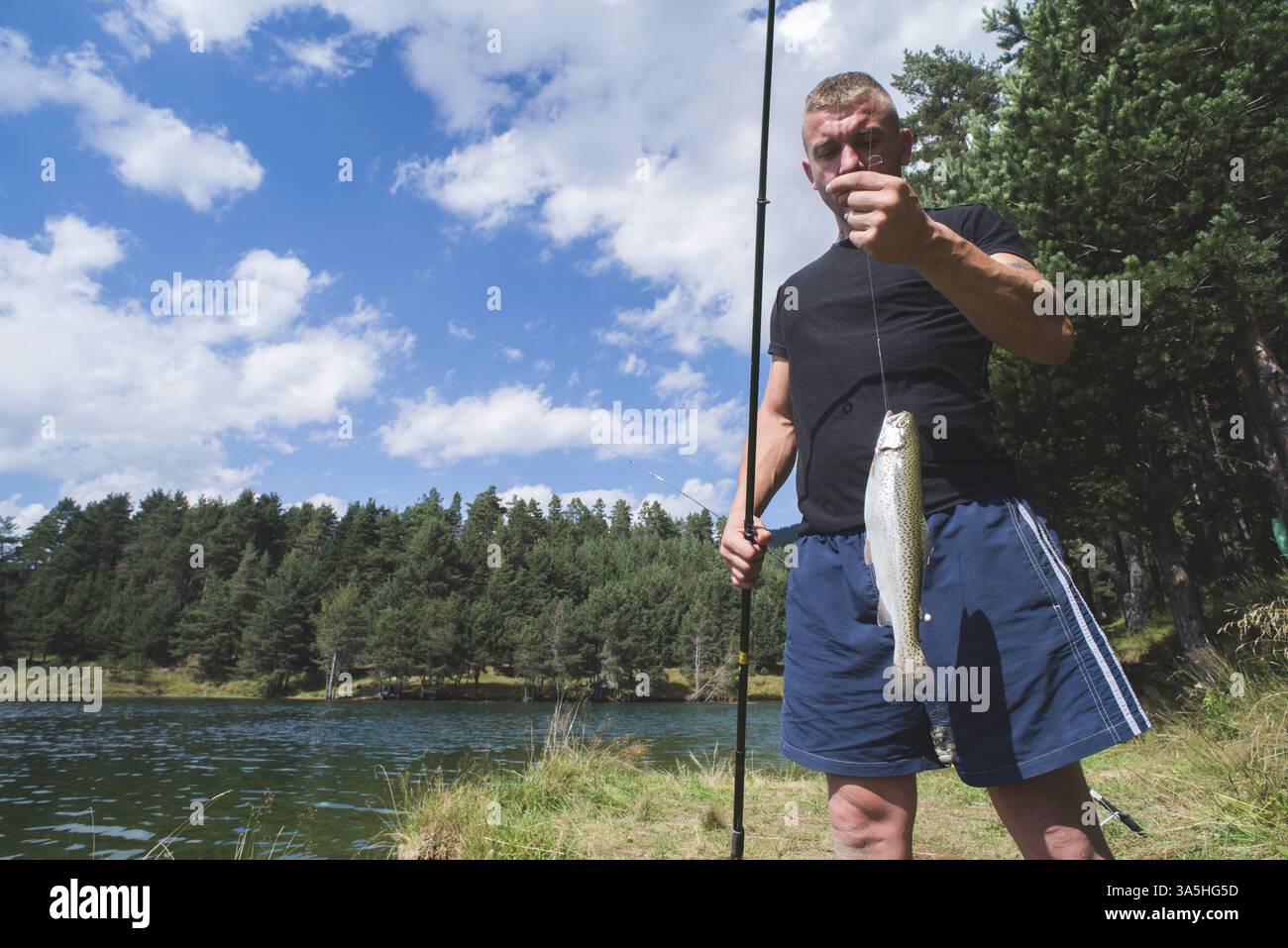 Fisherman caught a fish in mountain dam. Bulgaria Stock Photo - Alamy