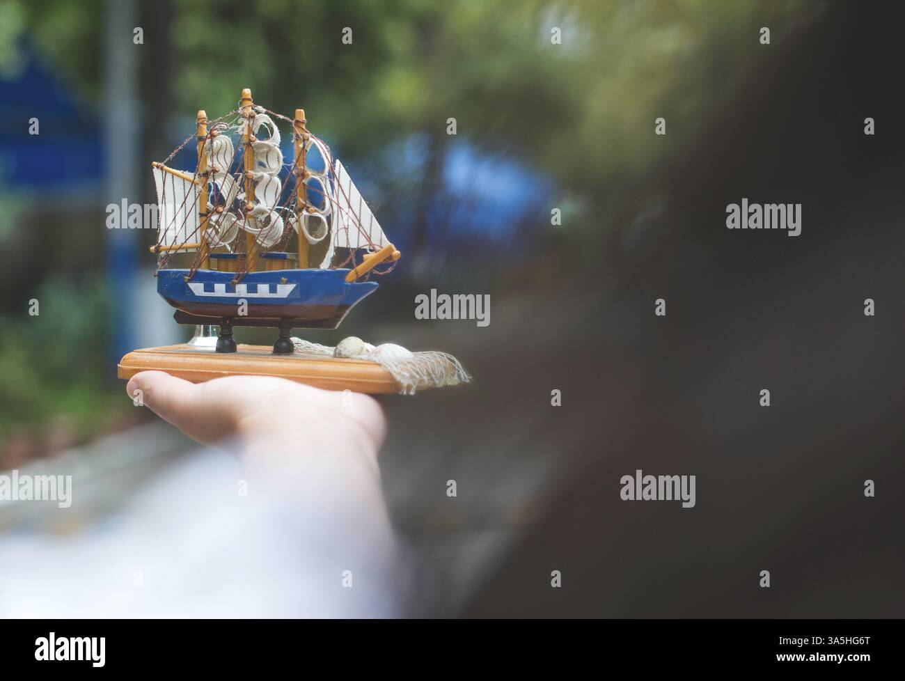 Hand holding model of a sailing ship Stock Photo - Alamy