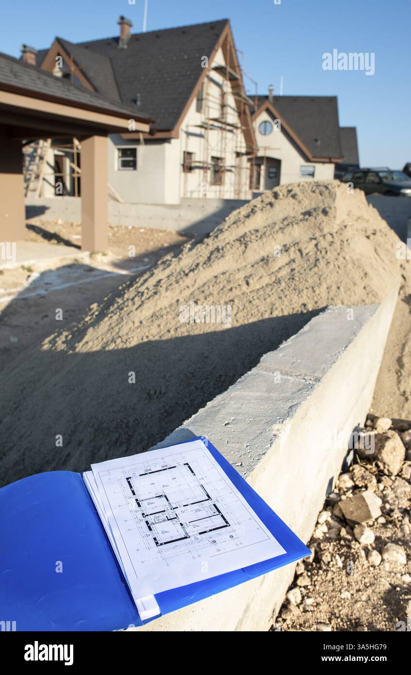 New build house and blueprints. Construction site Stock Photo - Alamy