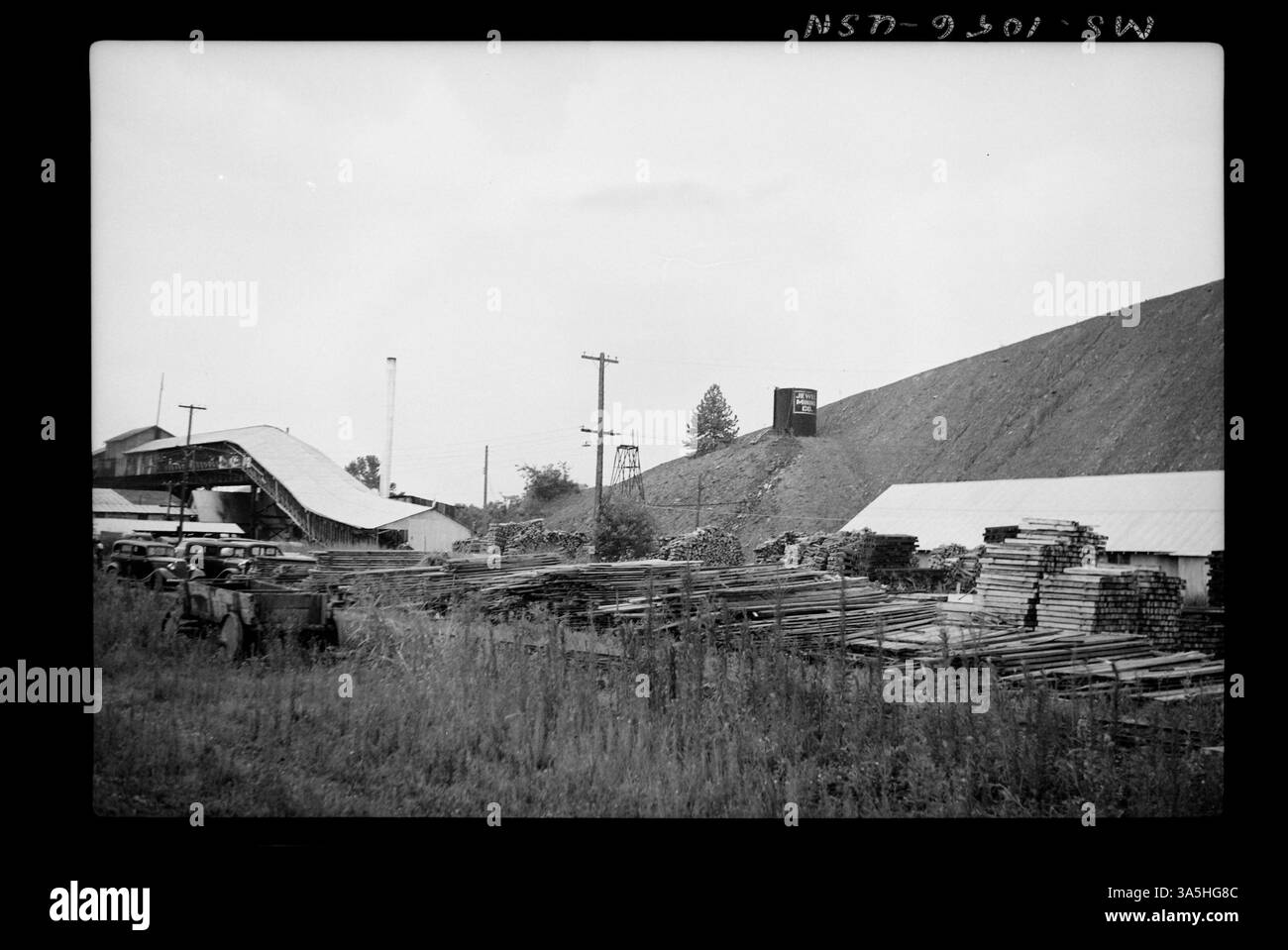 A view of the waste rock pile, water tank, and superstructure housing ...