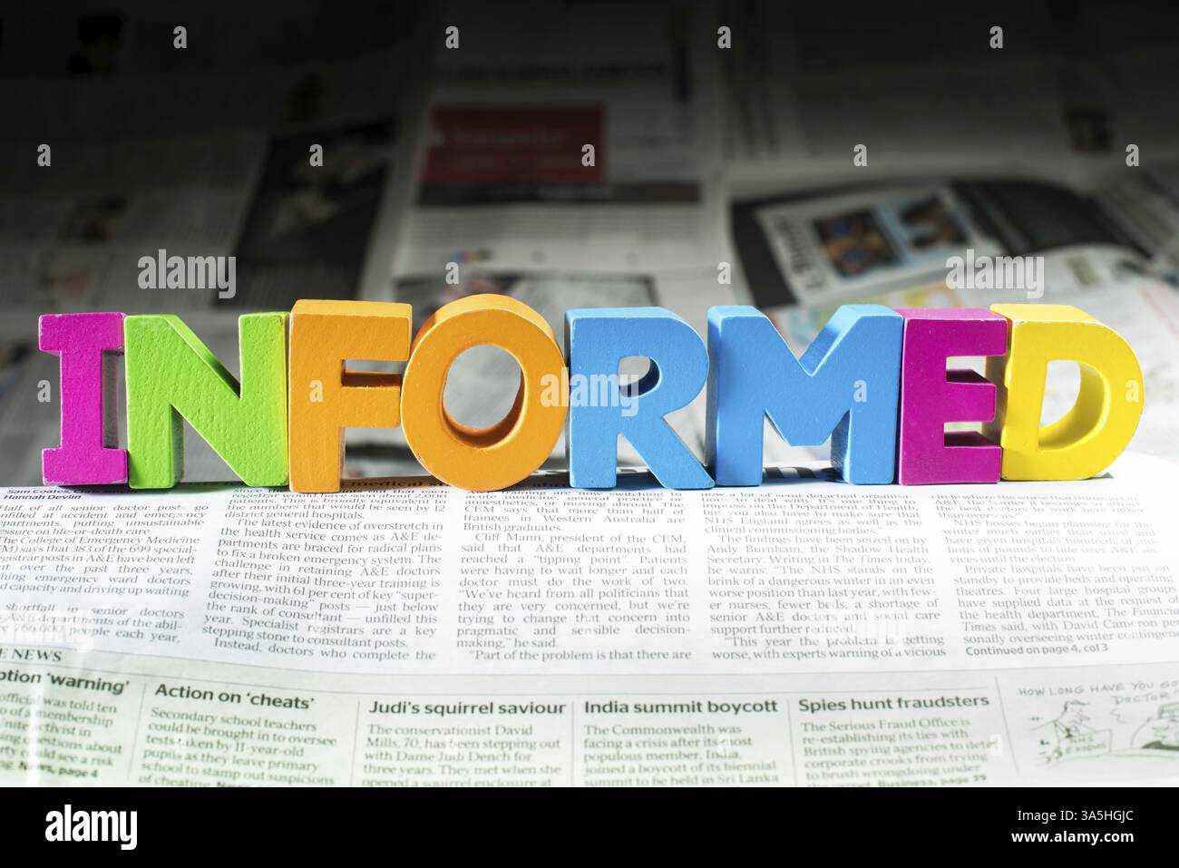 Word informed on newspaper. Wooden letters Stock Photo - Alamy