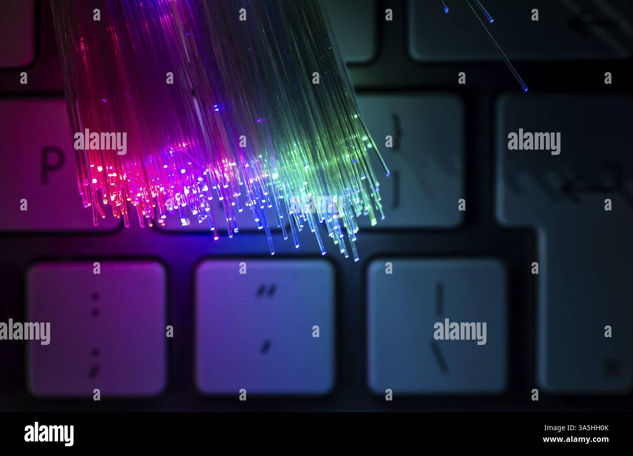 Colourful optic fibers illuminated on keyboard. High speed internet ...