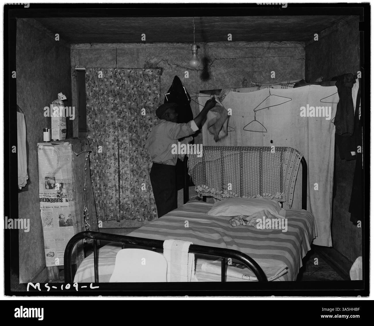 Amos Wilson, a miner, pictured in the bedroom of his home in a company ...