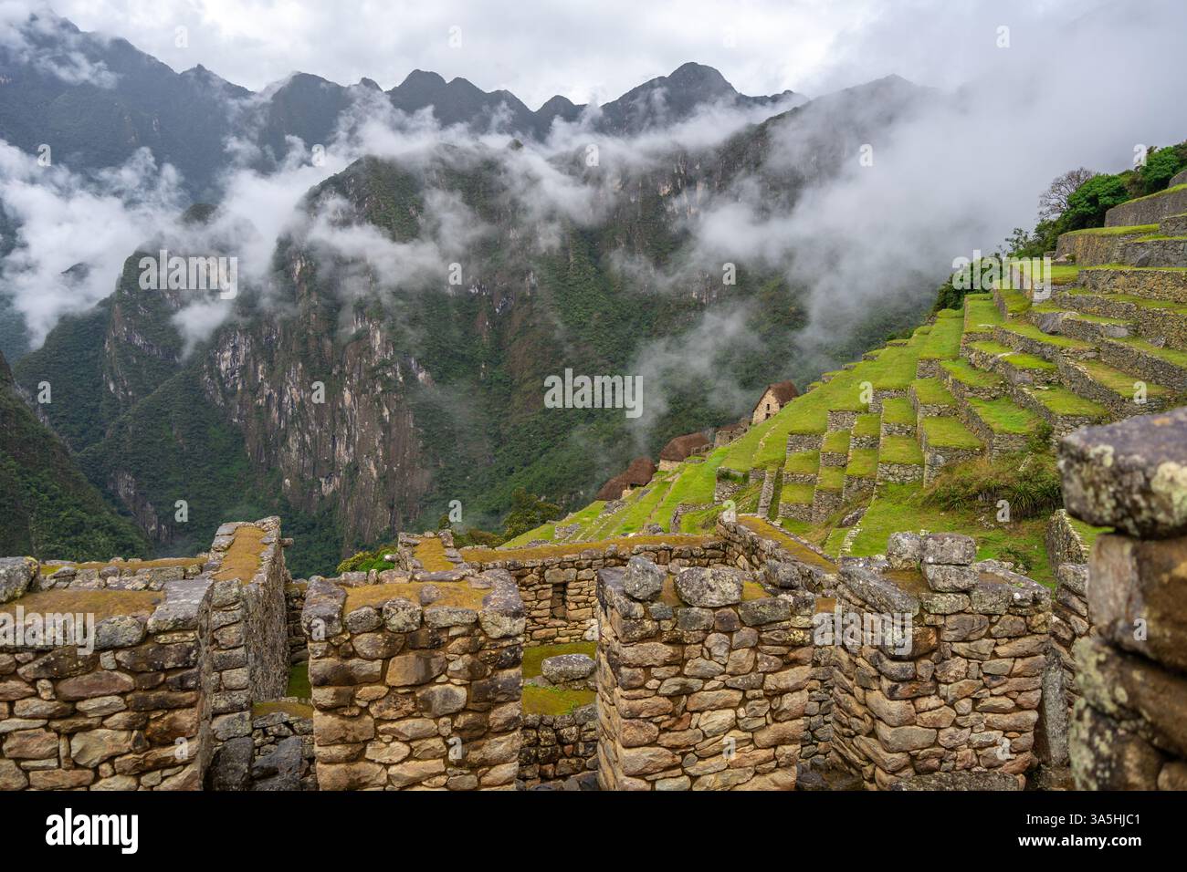Machu Picchu, the famous Inca citadel in Peru, is nestled among mist ...
