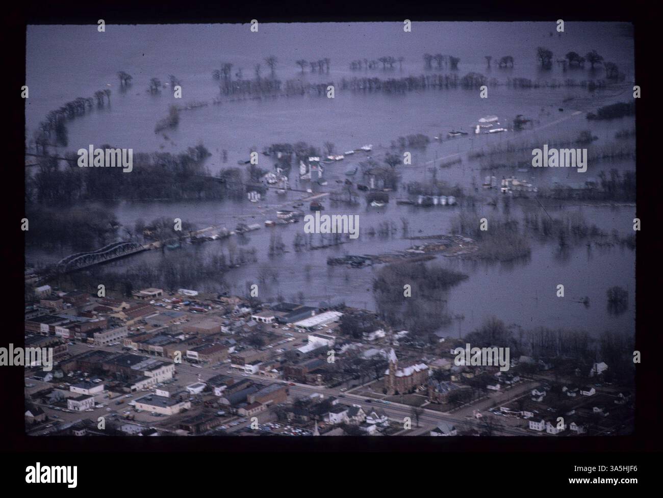 This aerial photograph shows St. Peter during the 1965 flood, with large portions of the city's ...