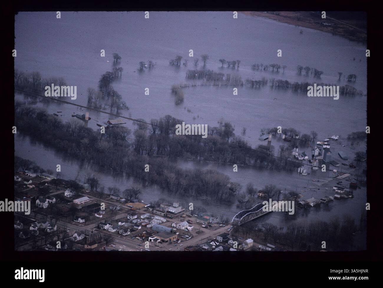 This aerial photograph from the 1965 flood shows the Minnesota River flooding St. Peter, with ...