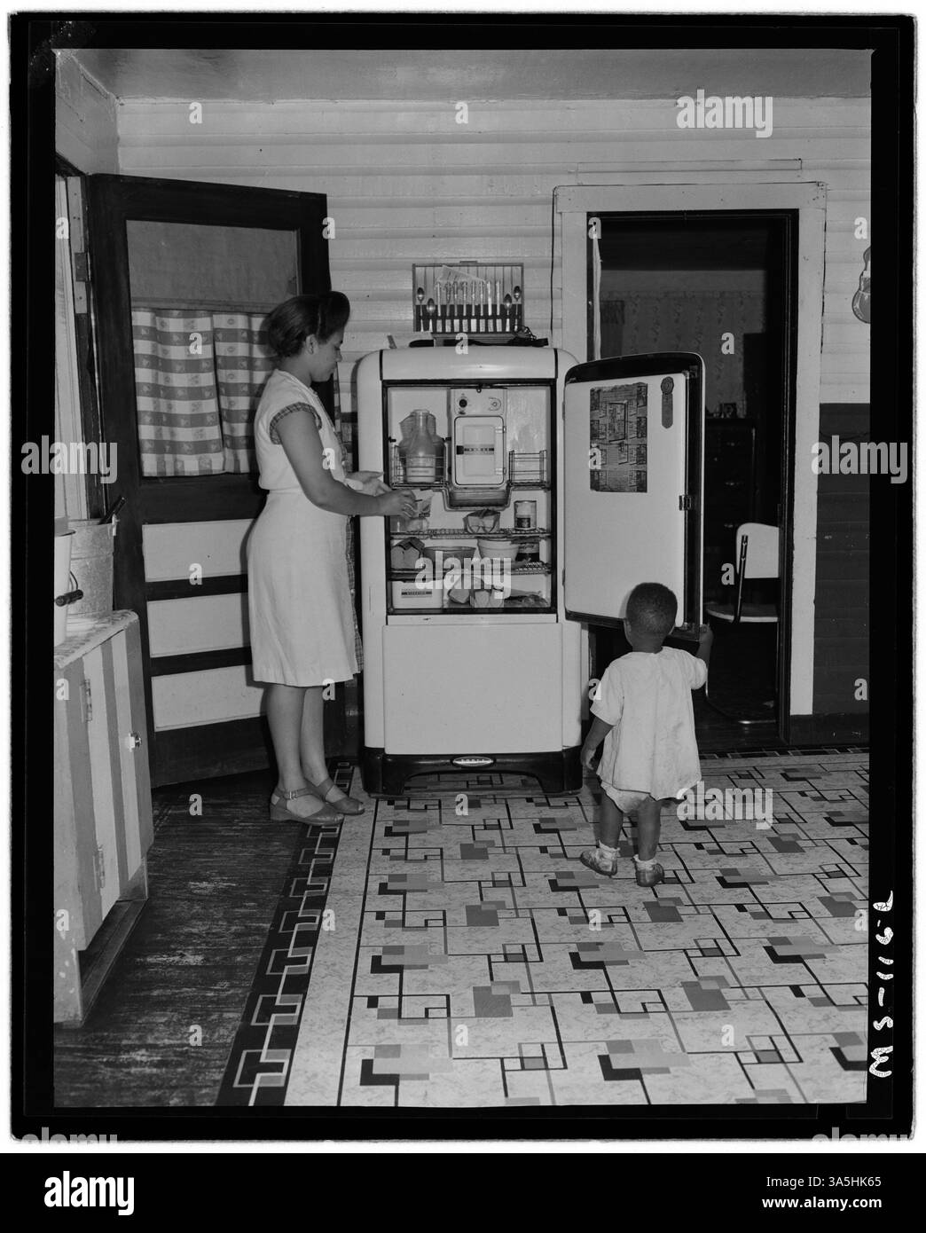 Mrs. Gonzalla Sullivan, wife of a miner, in the kitchen of her company ...