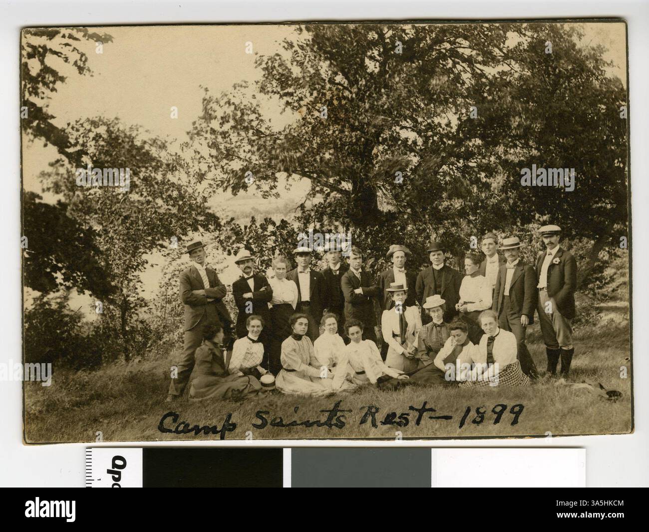 This image from 1899 shows a group of people relaxing at Camp Saints ...