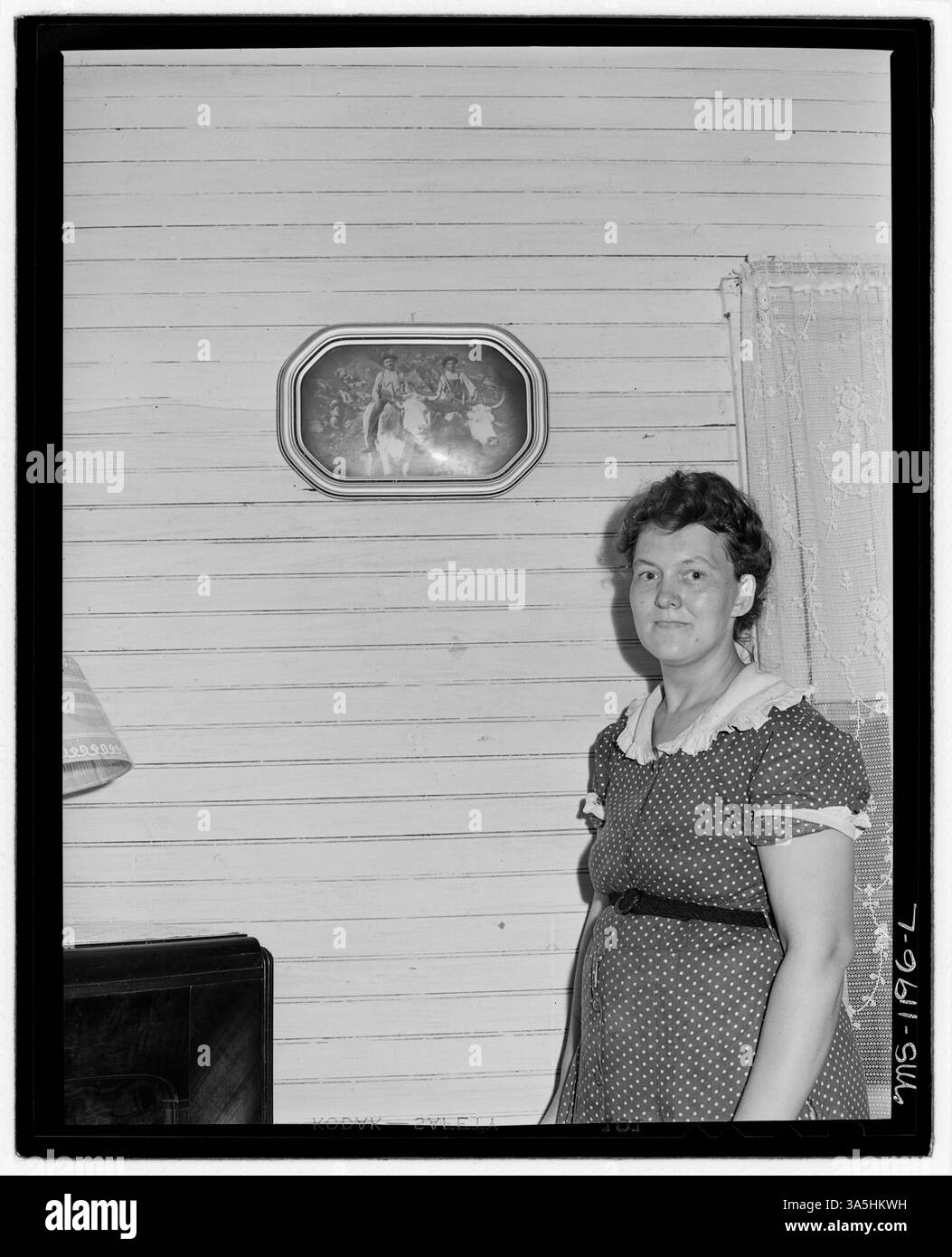 Mrs. Clay Hearl, wife of a miner, holding a photo of her husband's ...