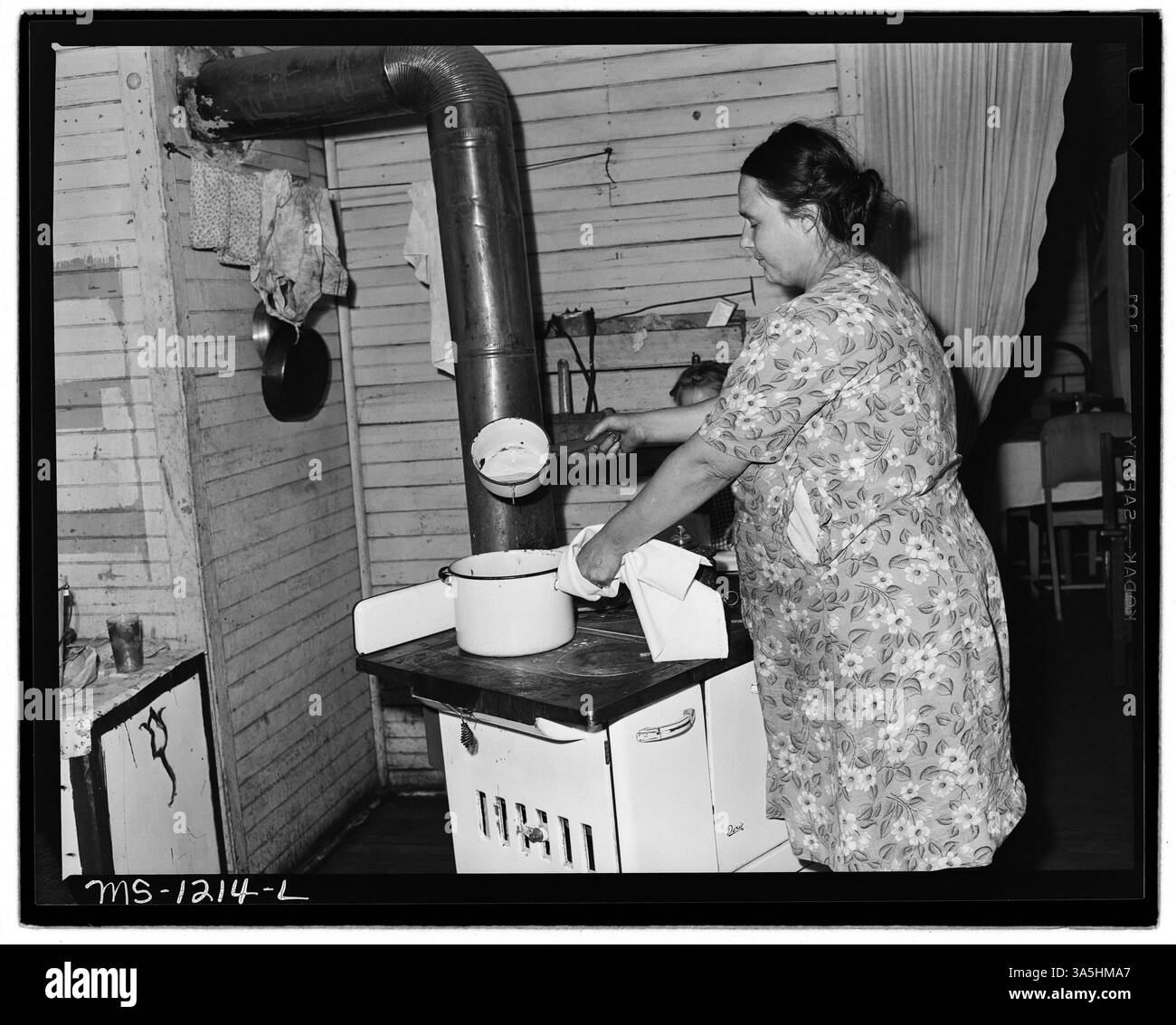 Mrs. J. F. Bryant, wife of a miner, in her kitchen of a two-family ...
