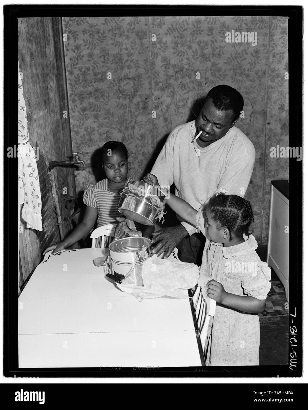 Julius Brooks and his daughters look at a new lunch pail, while Brooks ...