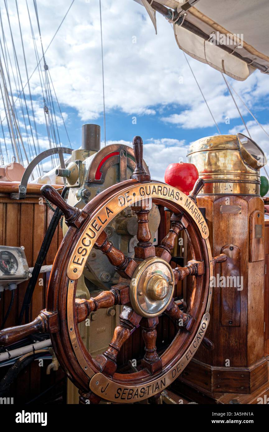 A large wooden steering wheel with the word Escuela de Guardias on it ...