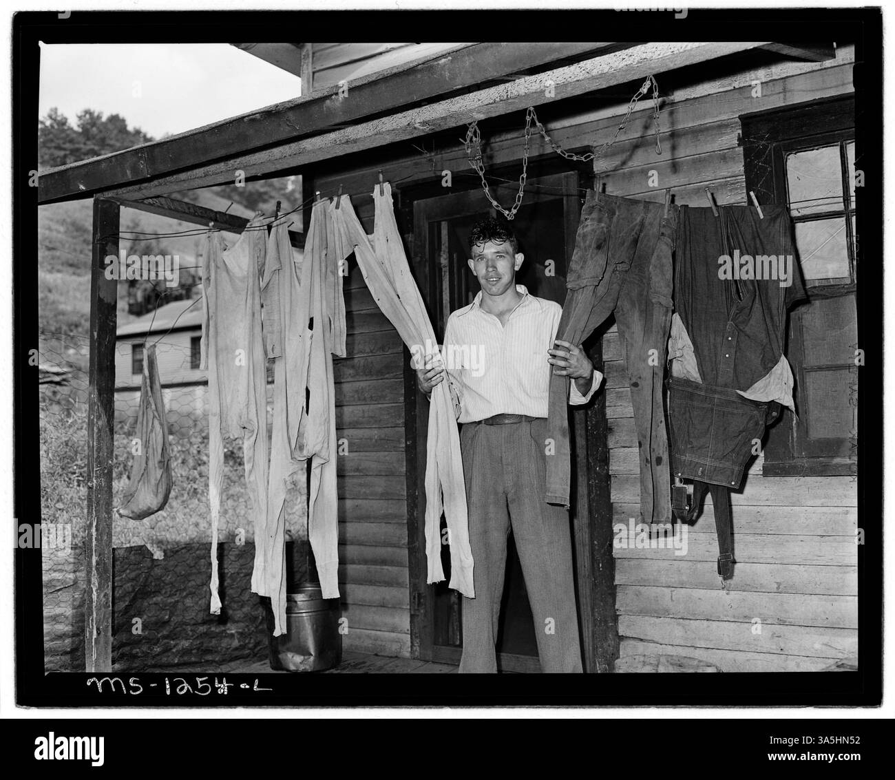 A miner's son stands on the back porch of the Big Sandy Housing Camp in ...