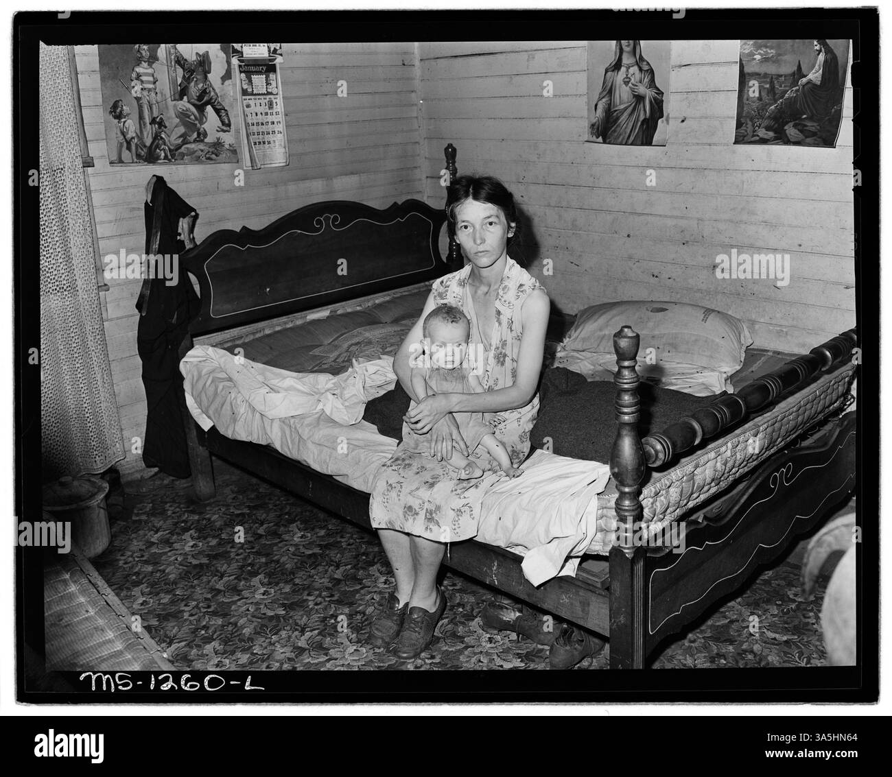 Mrs. Walter Rose holds her malnourished baby in their unsanitary ...