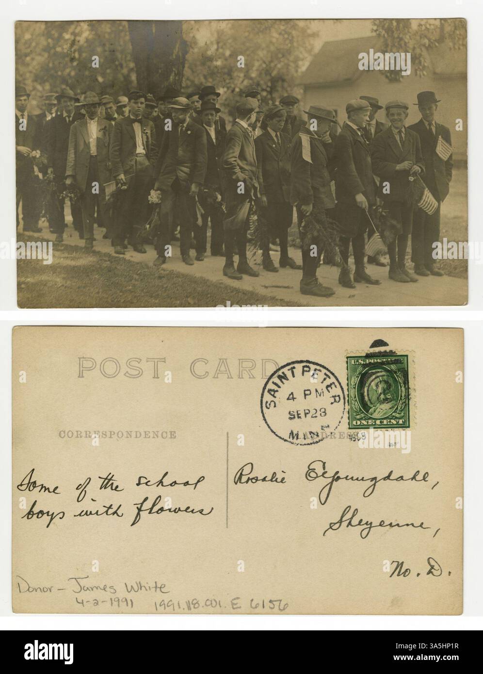 This postcard shows a group of schoolboys observing the funeral ...