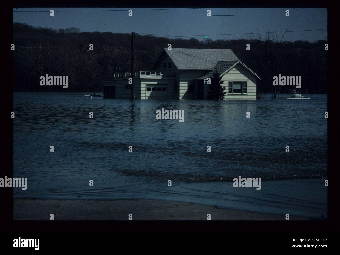 This image shows a flooded home along the north side of Highway 22 on ...