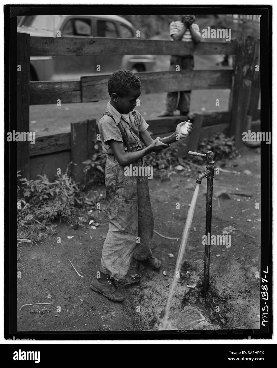 James Robert Howard's son washes his hands before supper at the Gilliam ...