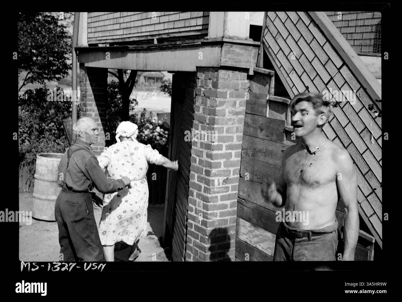 Lt. Commander O'Farrell standing by an outdoor hydrant in Slovan ...
