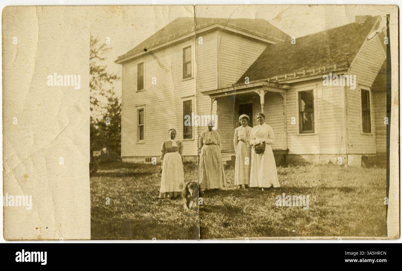 A photograph of four unidentified women standing outside the Rognlie ...