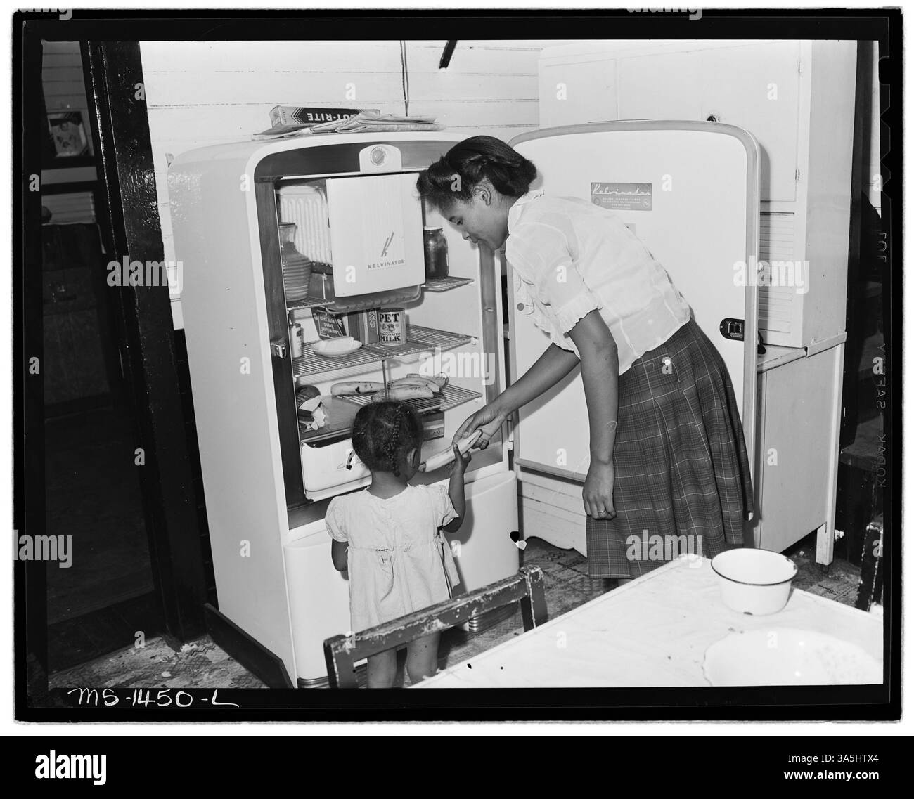 In the home of Mrs. James Robert Howard, she gives her daughter a ...