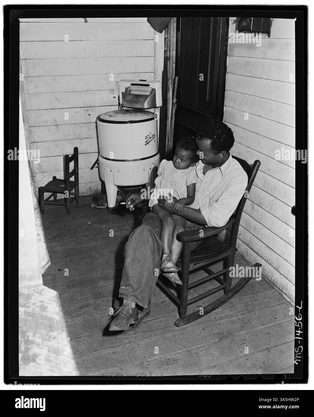 James Robert Howard and his daughter are pictured on the front porch of ...