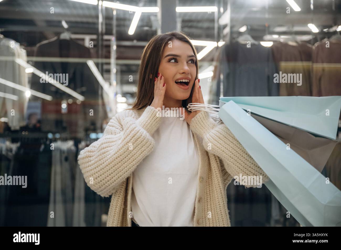 Shocked facial expression. Beautiful woman is in the mall, conception ...