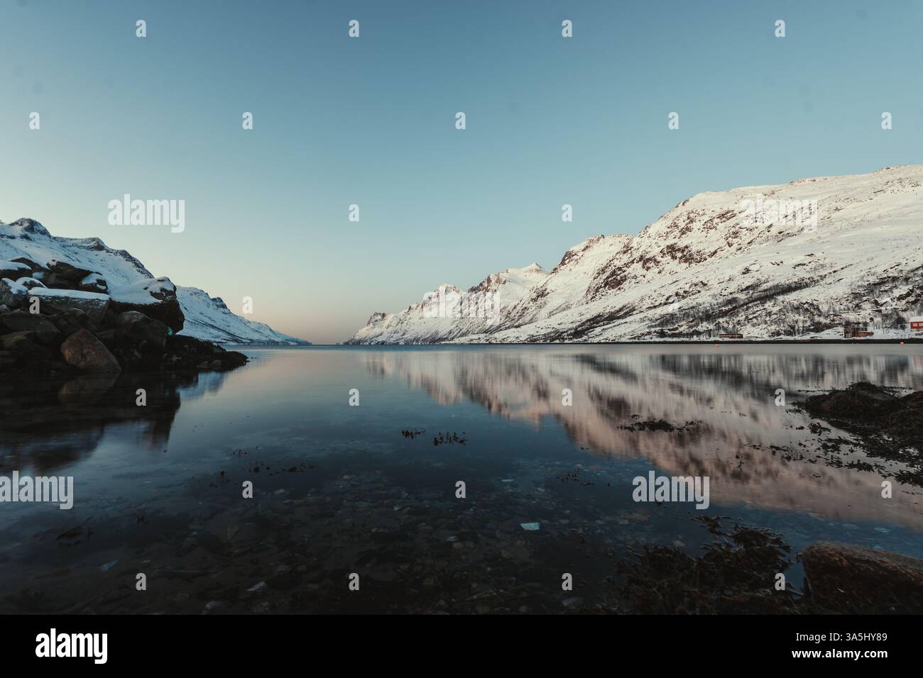 Arctic ocean with mountains reflection at Ersfjord near Tromso, Norway ...