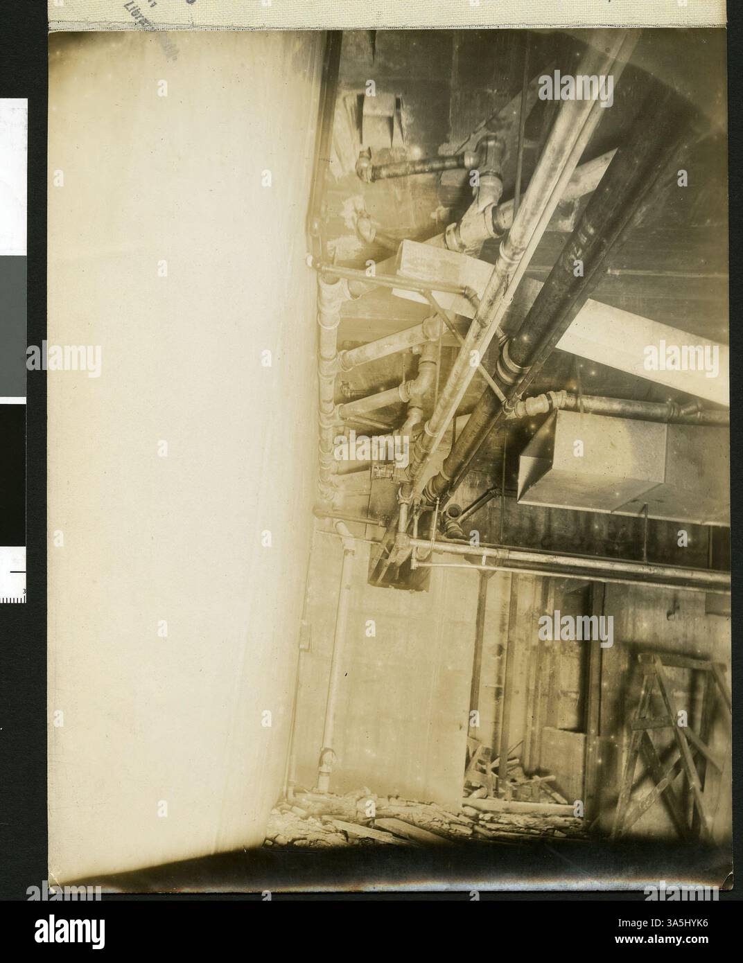 The photograph depicts the installation of a ventilation system hi-res ...
