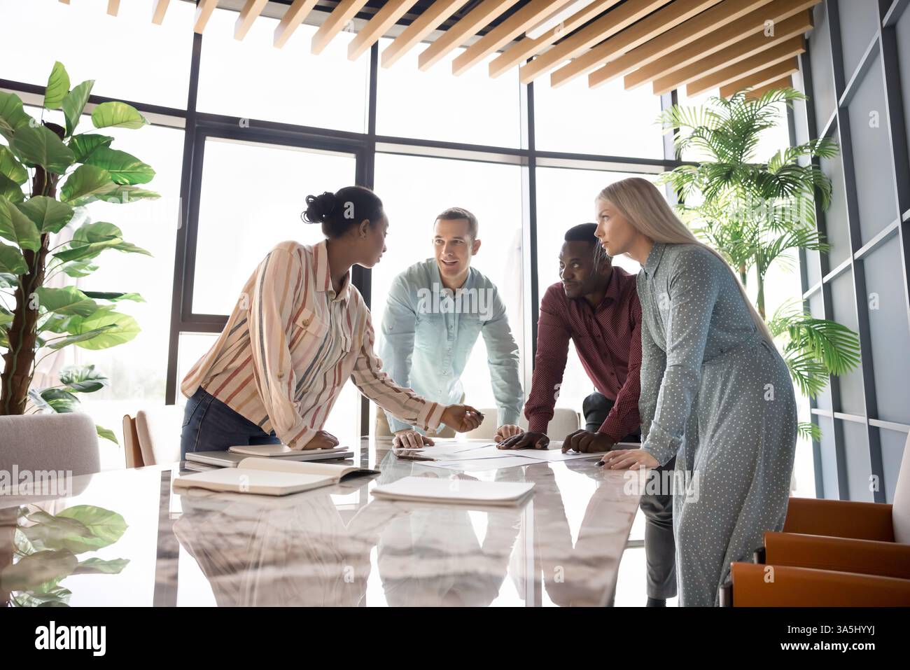 Team gathered in modern conference hi-res stock photography and images ...