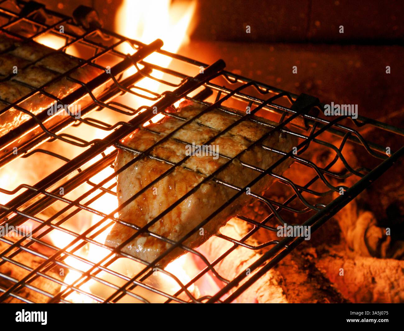 Fish fillets grilled over an open fire Stock Photo - Alamy