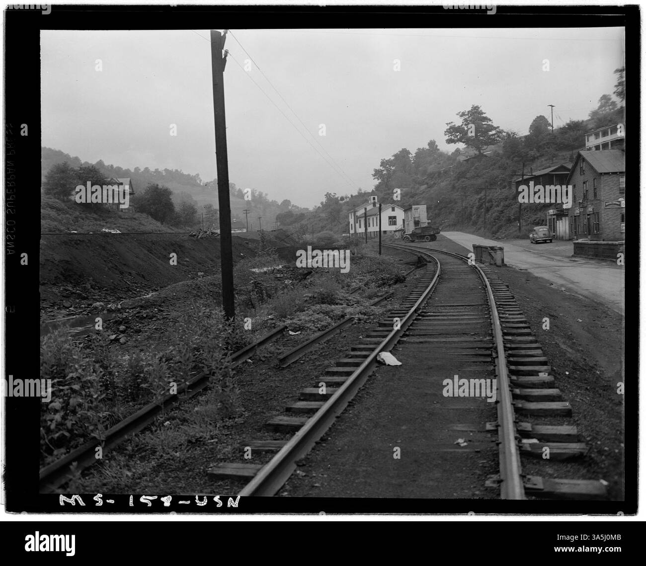 A view of railroad tracks running through a town, showcasing the ...