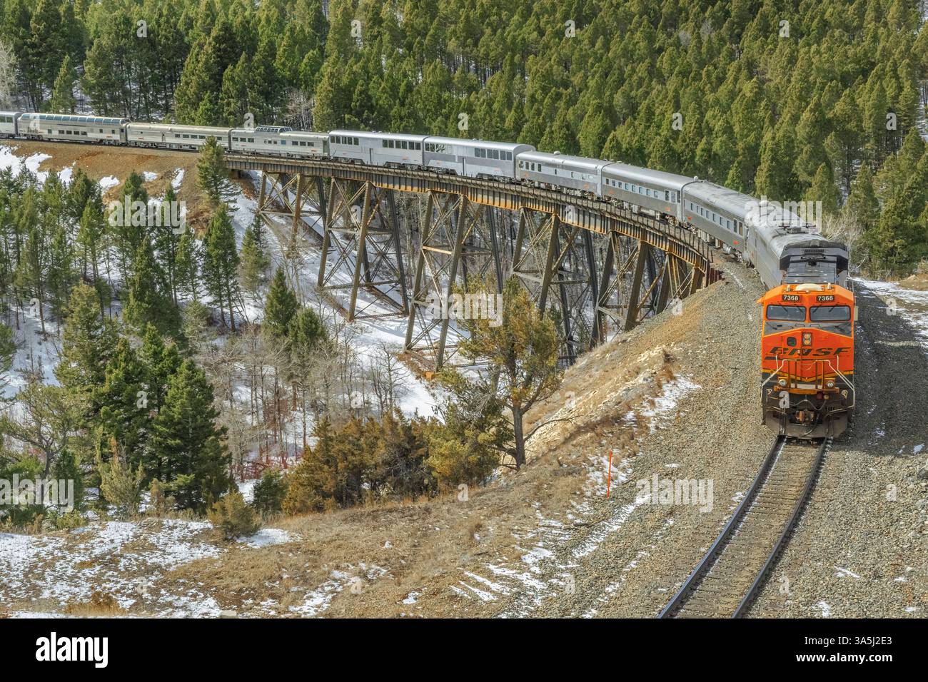 passenger train heading to mullan pass over a trestle near austin ...