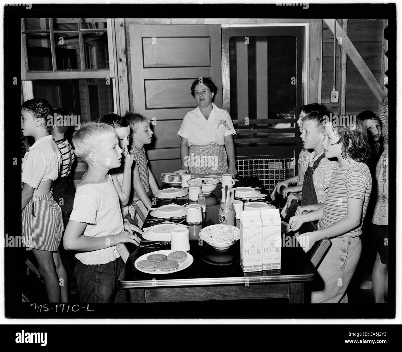 Campers sing before their noon meal at Camp Thomas E. Lightfoot, Hinton ...
