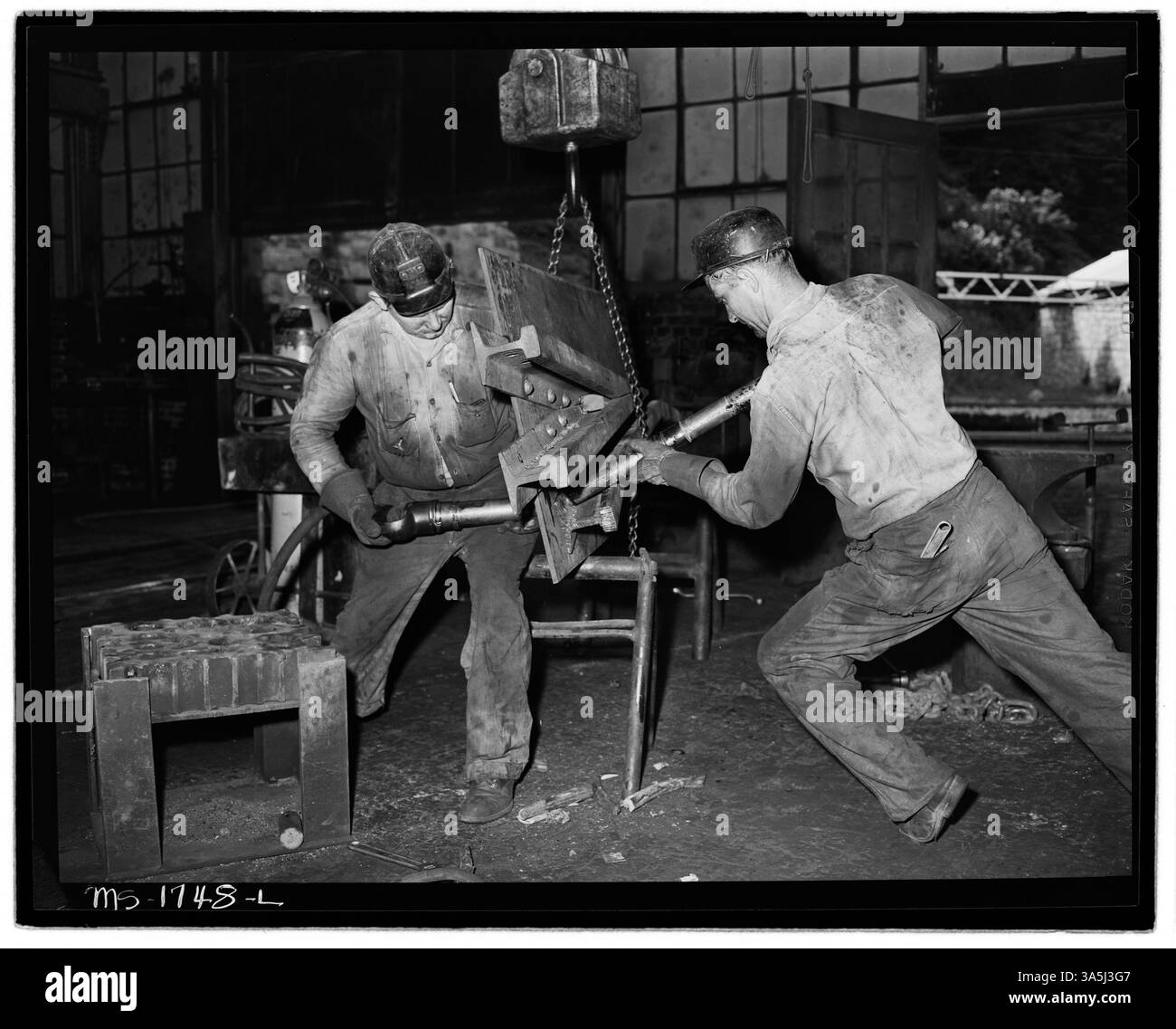 Woodrow Lamb and Cyrus Williams are seen riveting a railroad frag onto ...