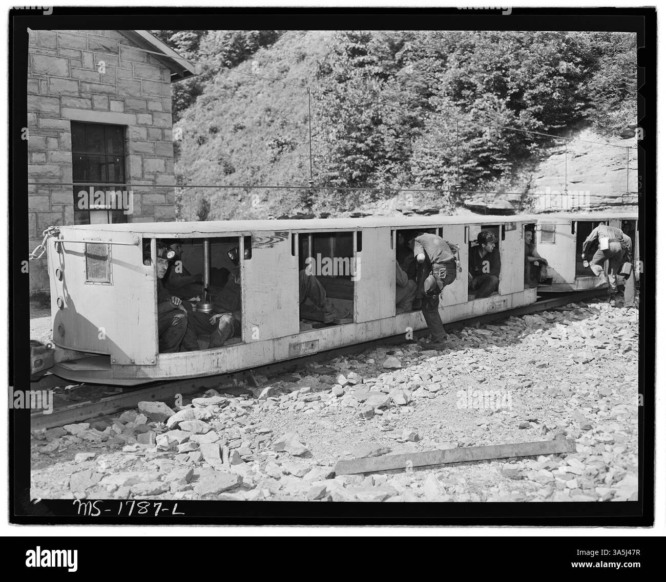 Miners prepare to board cars for a man trip before heading underground ...