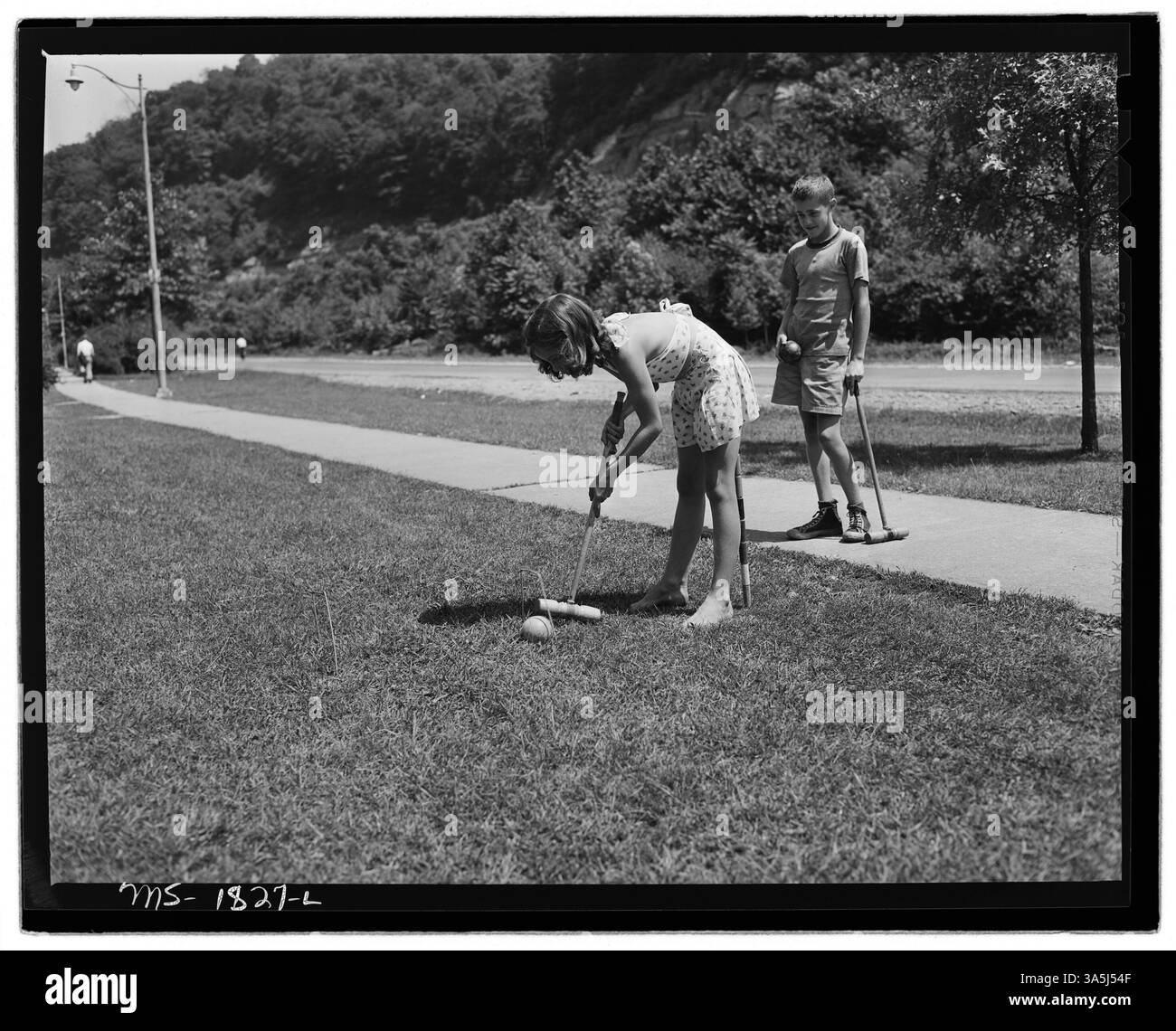 Miners and their families are seen playing croquet on the lawn of a ...
