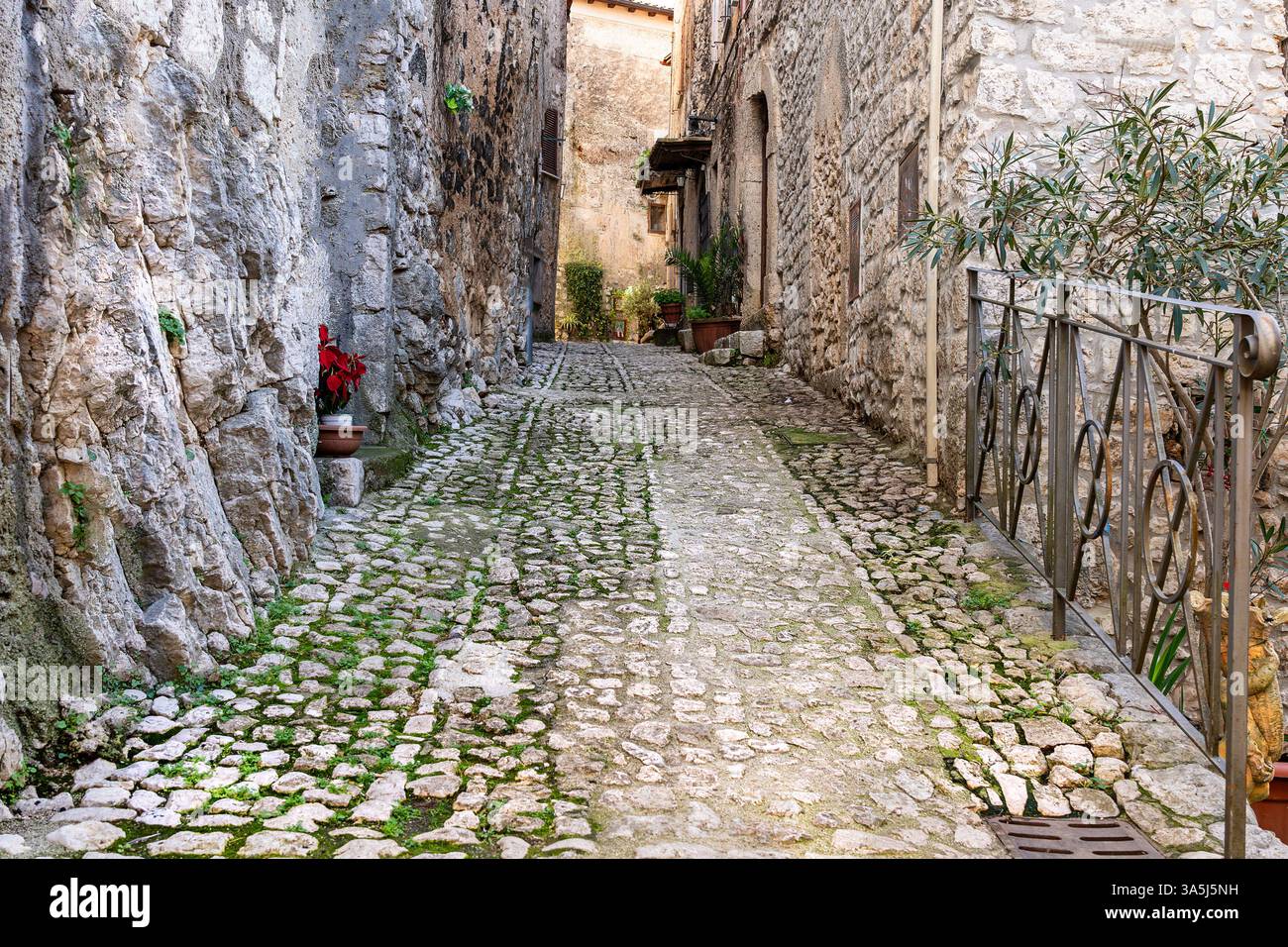 downhill alley paved with stone cobblestones and a mouldy staircase in ...